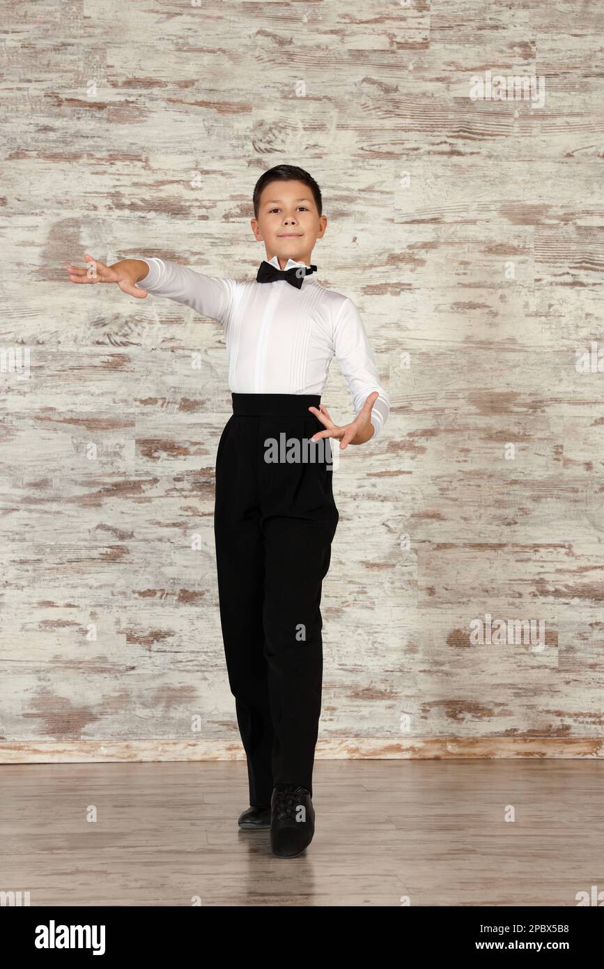 Beautifully dressed little boy dancing in studio Stock Photo - Alamy