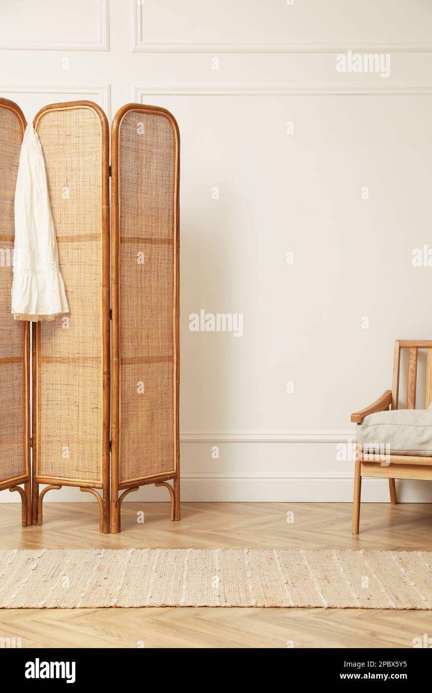 Stylish room with folding screen and armchair. Interior design Stock ...