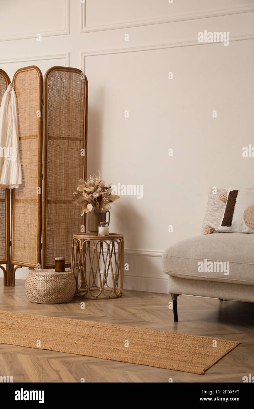 Stylish living room with folding screen and sofa. Interior design Stock ...