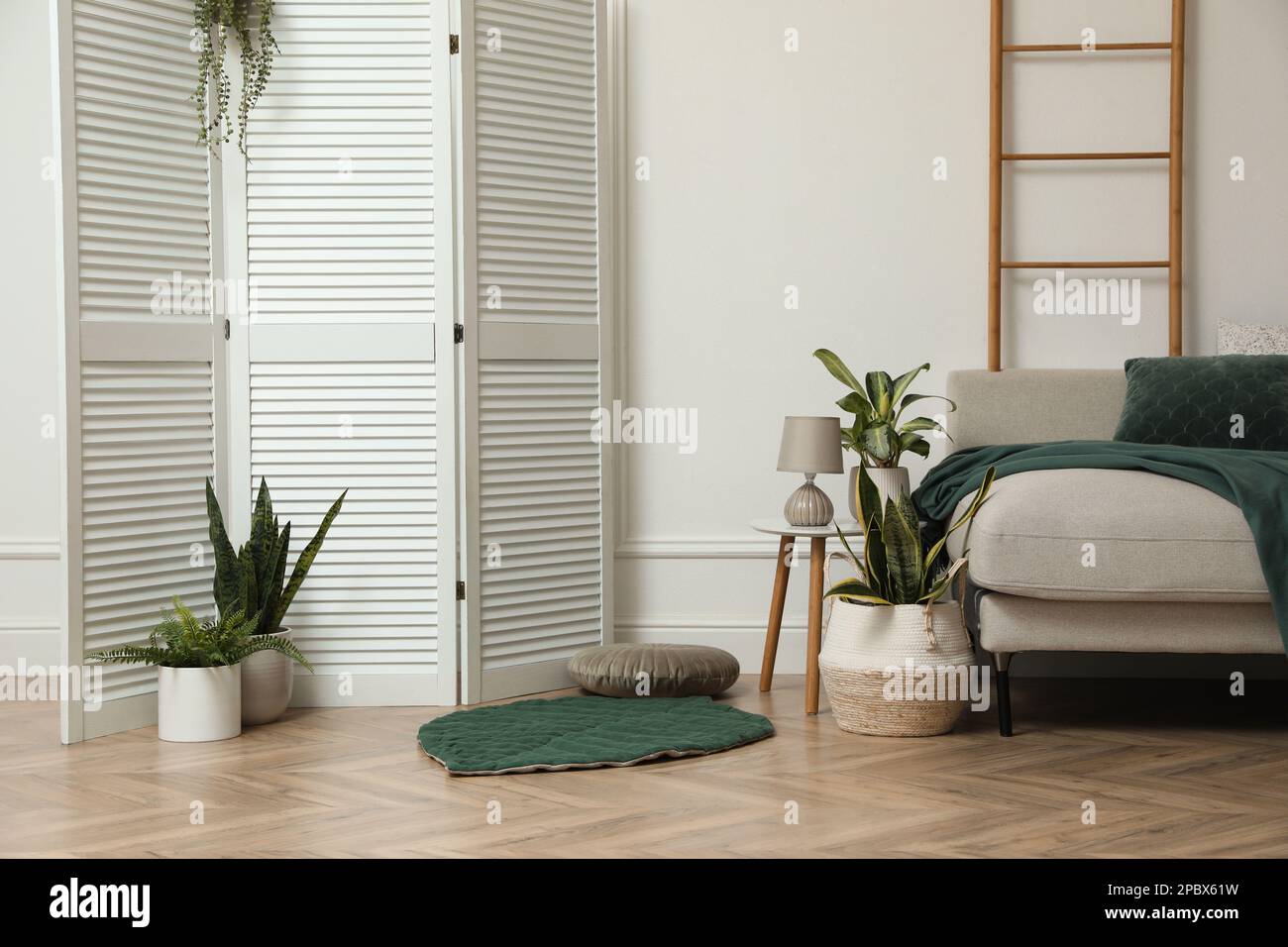 Stylish living room with folding screen and sofa. Interior design Stock ...