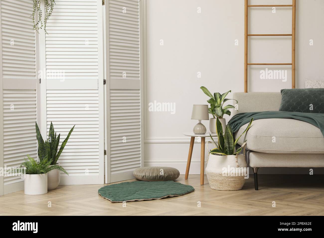 Stylish living room with folding screen and sofa. Interior design Stock ...