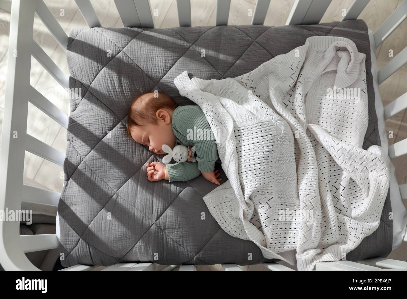 Cute little baby sleeping in crib, top view. Bedtime Stock Photo - Alamy