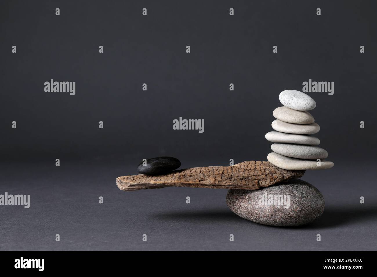Stones with tree branch on black background. Harmony and balance ...
