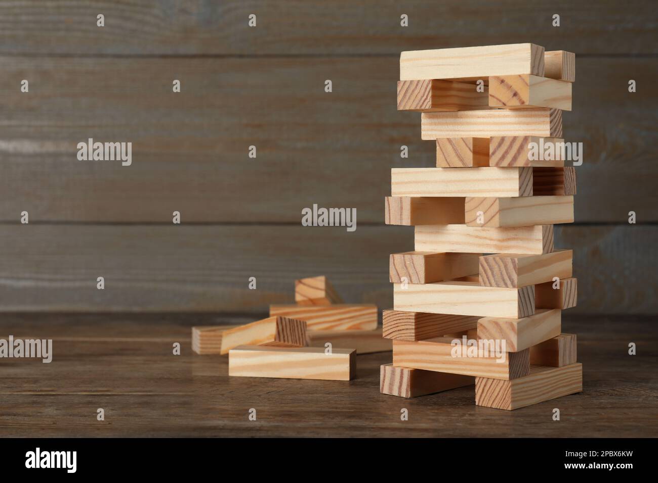 Jenga tower made of wooden blocks on table, space for text Stock Photo ...