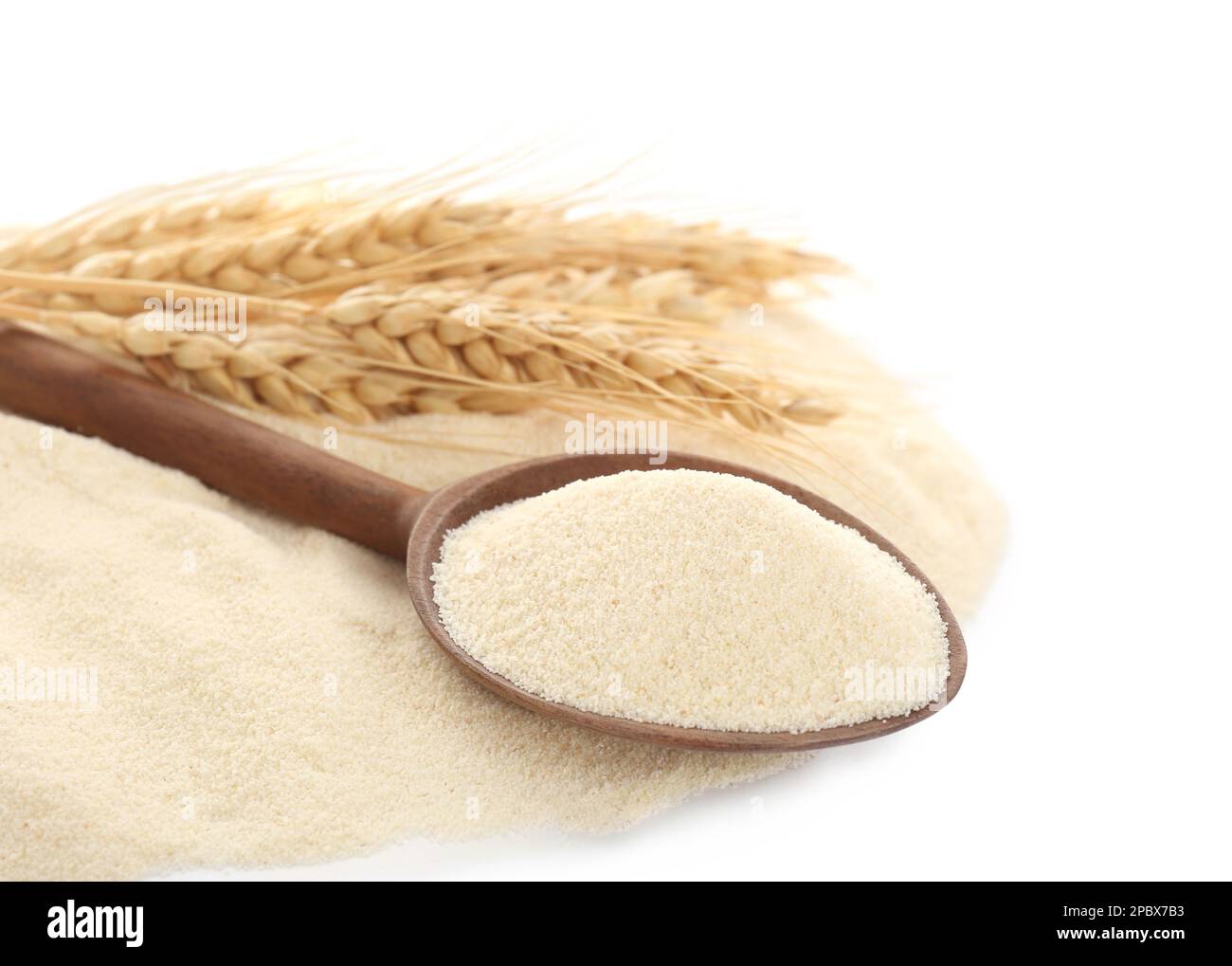 Spoon with semolina and spikelets on white background Stock Photo - Alamy