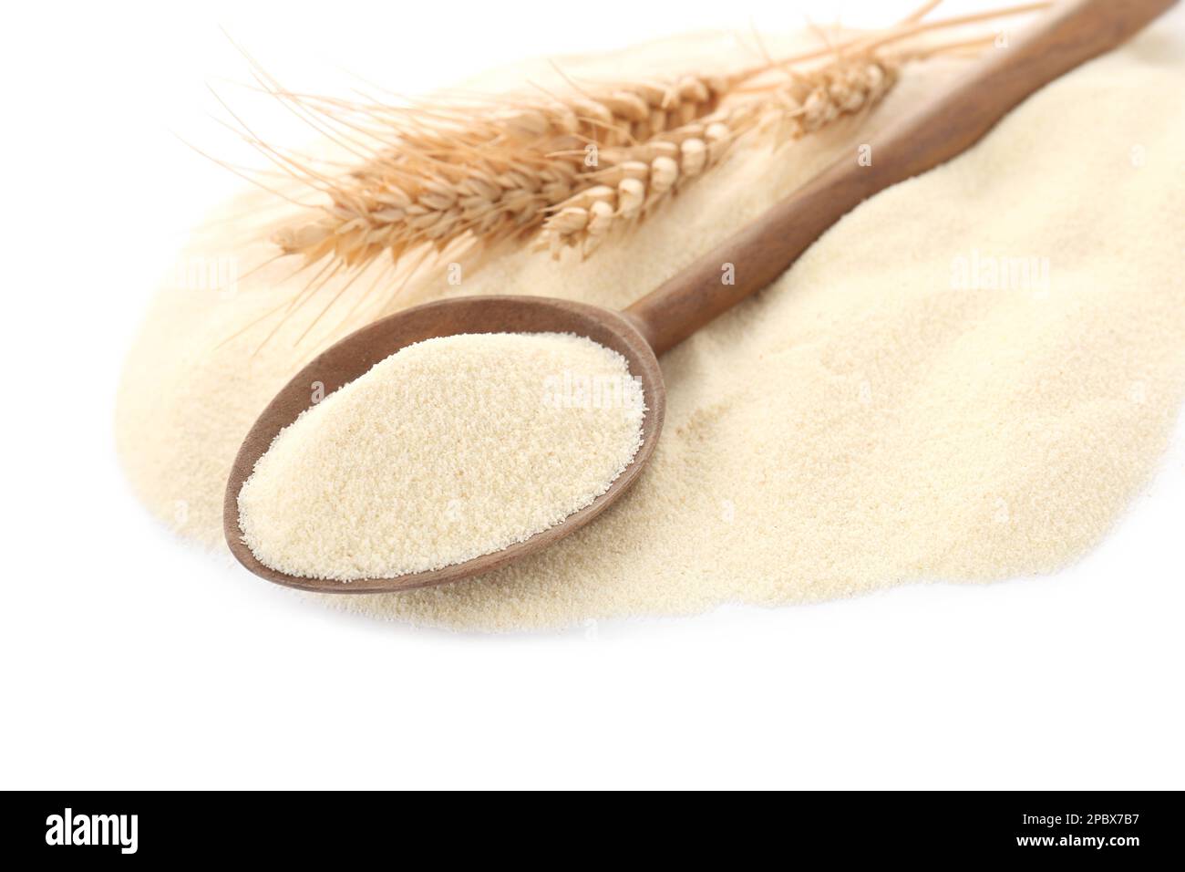 Spoon with semolina and spikelets on white background Stock Photo - Alamy