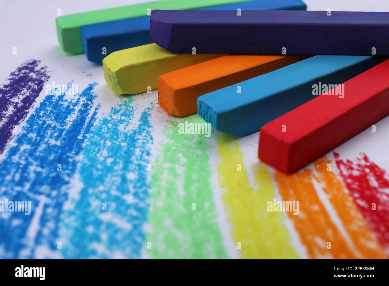 Colorful pastel chalks and scribbles on white background, closeup ...