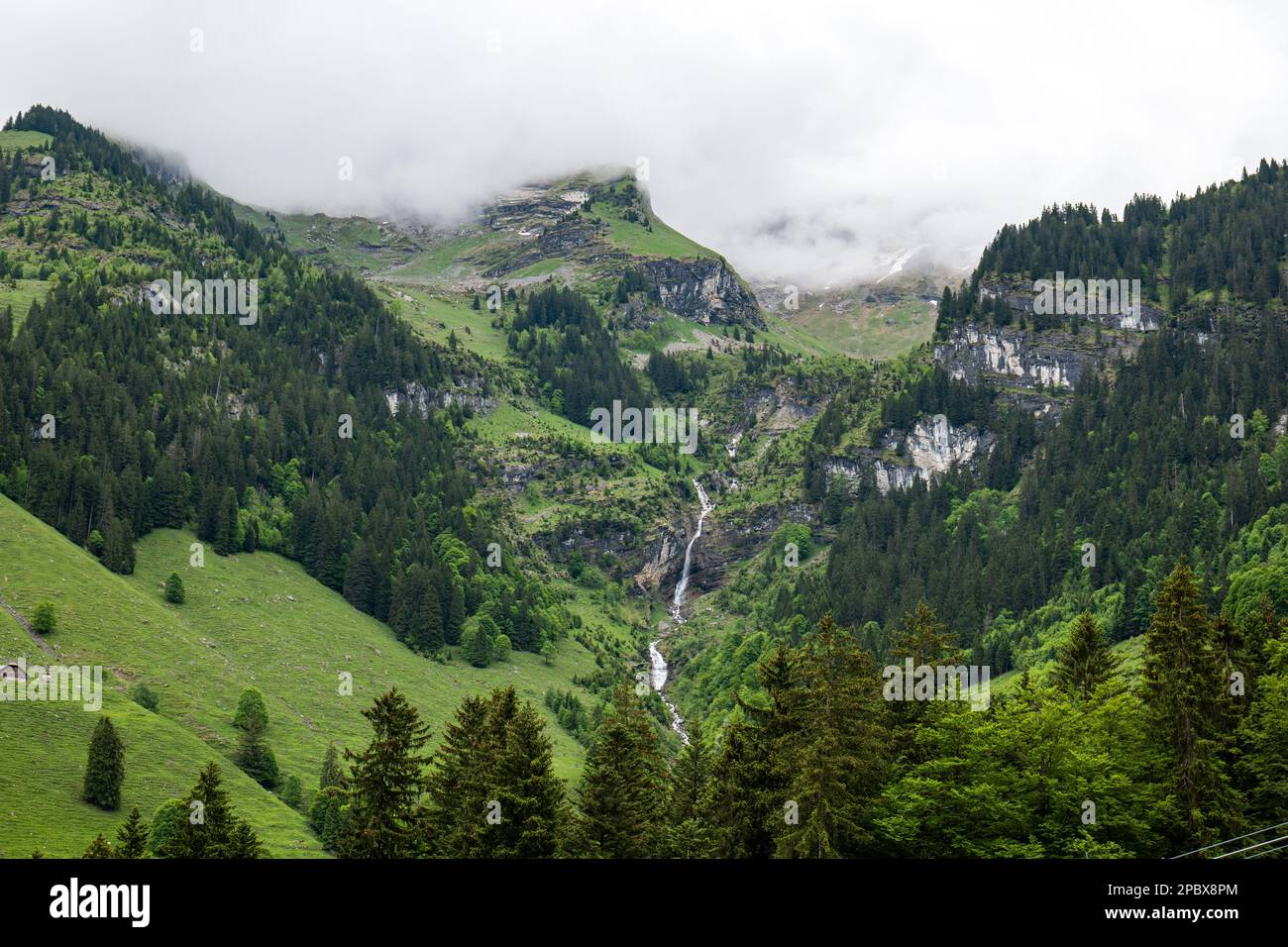Dramatic view of a green valley in the Swiss Alps. Cloudy day, high ...