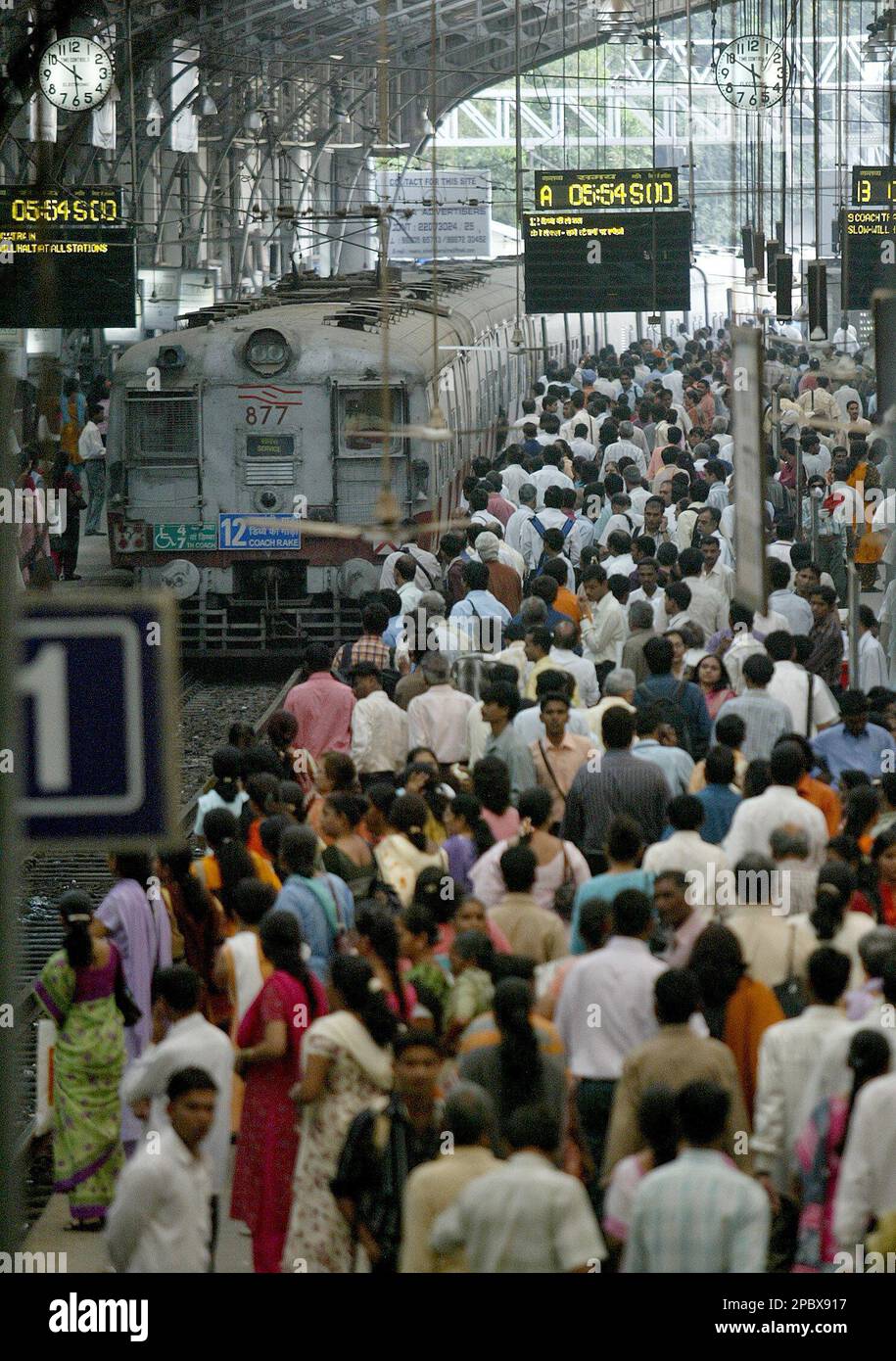 Commuters crowd to board local trains in Mumbai, India, Monday, Feb. 26 ...