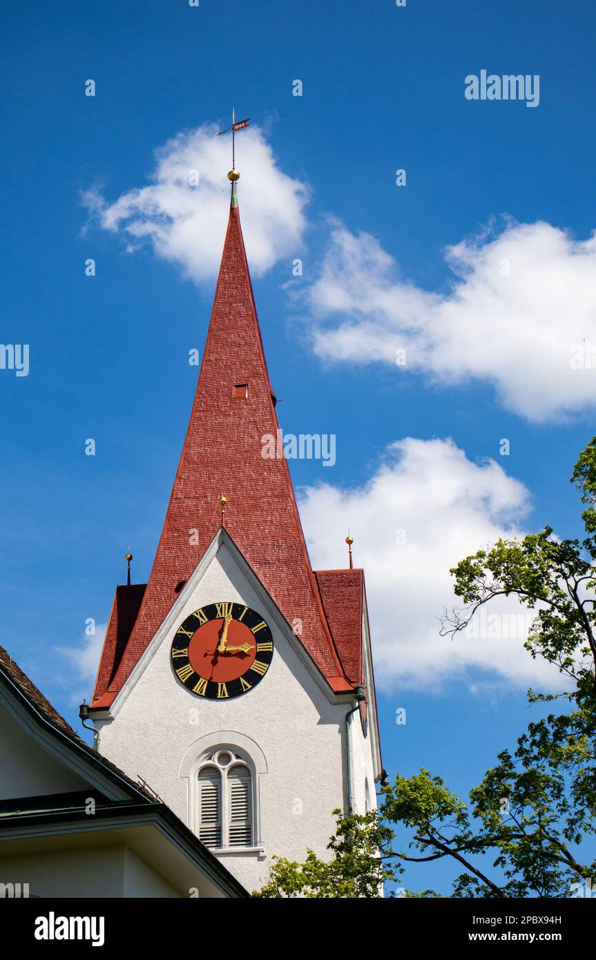 Church clock bell tower set against a blue sky. Sunny day, Switzerland ...