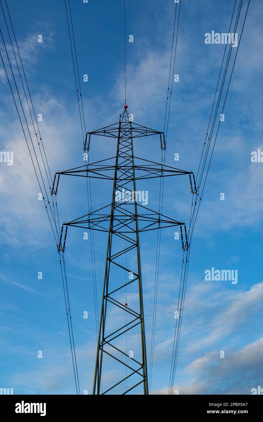 Large power lines metal carrier pylons in Europe. Low angle shot ...