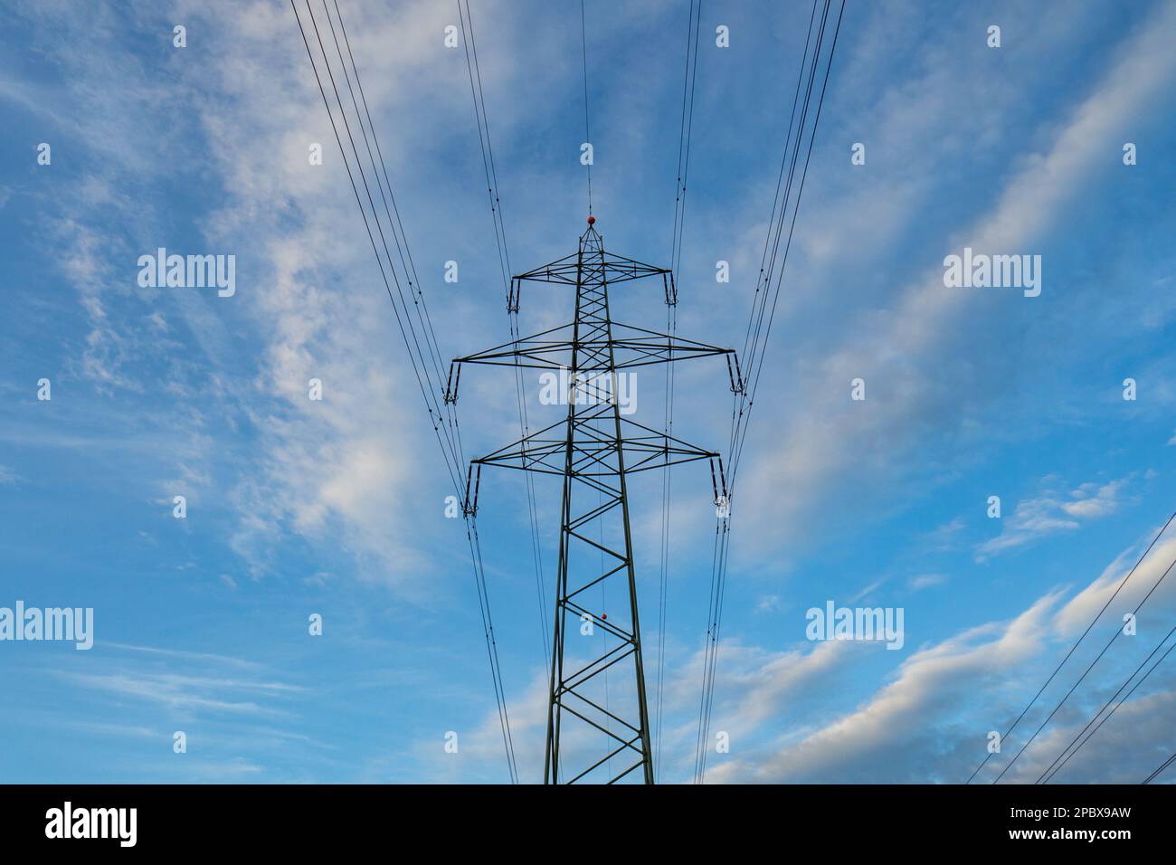 Large power lines metal carrier pylons in Europe. Low angle shot ...
