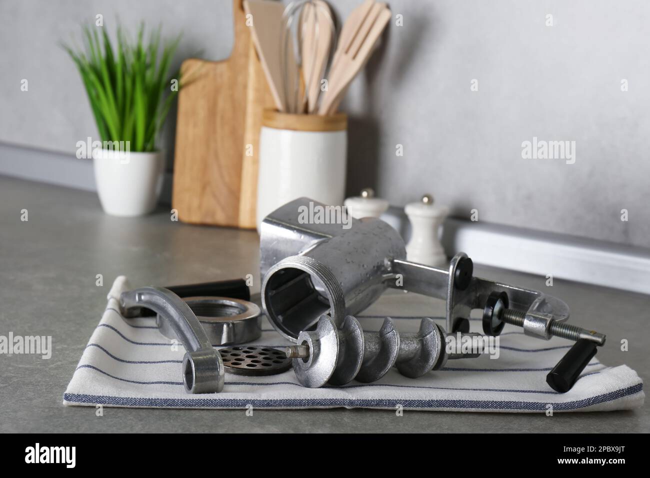 Clean parts of manual meat grinder on grey table indoors Stock Photo ...