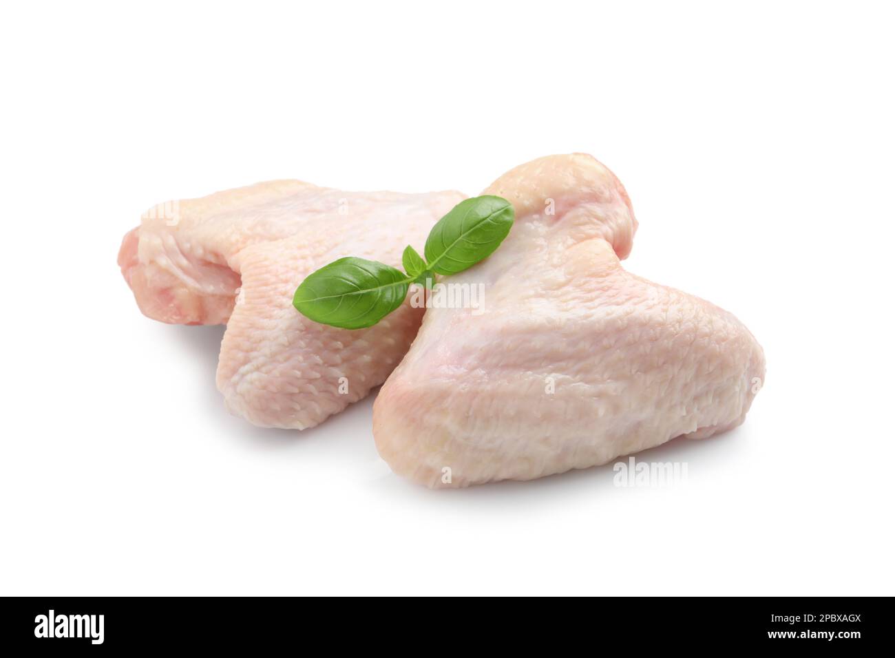 Raw chicken wings with basil on white background Stock Photo - Alamy