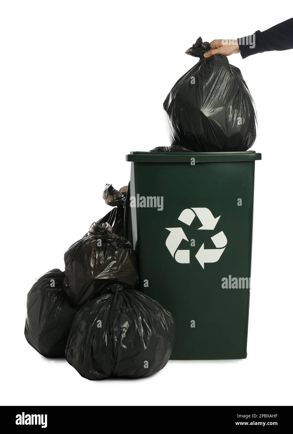 Man putting garbage bag into recycling bin on white background, closeup ...