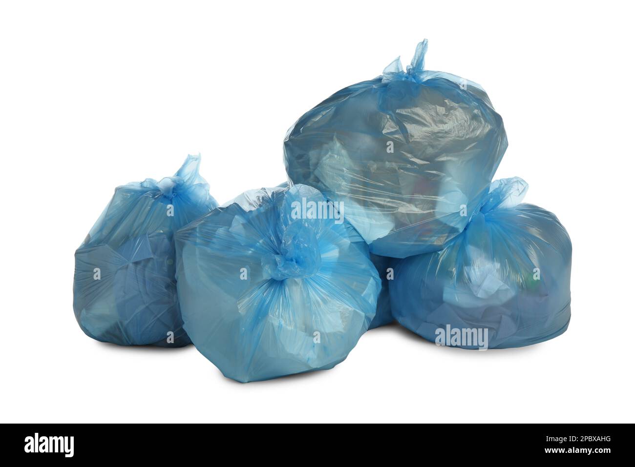 Blue trash bags filled with garbage on white background Stock Photo - Alamy