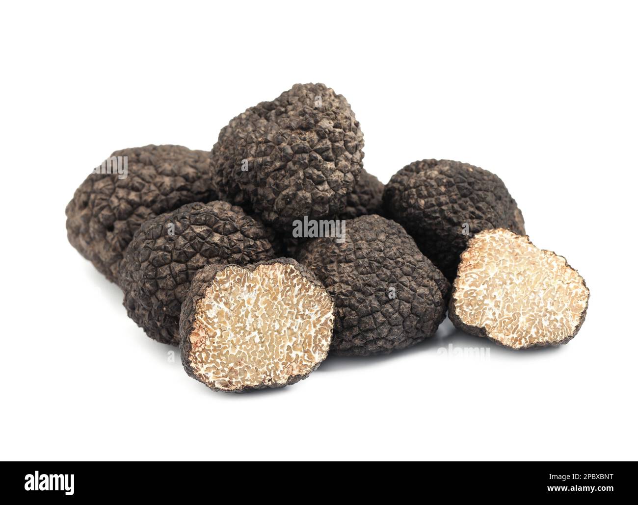 Cut and whole black truffles isolated on white Stock Photo - Alamy