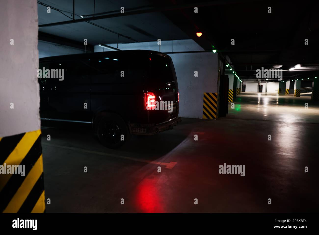 Black van in parking garage at night Stock Photo - Alamy