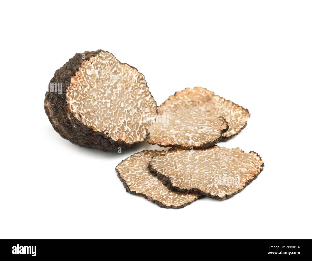 Cut fresh black truffle isolated on white Stock Photo - Alamy