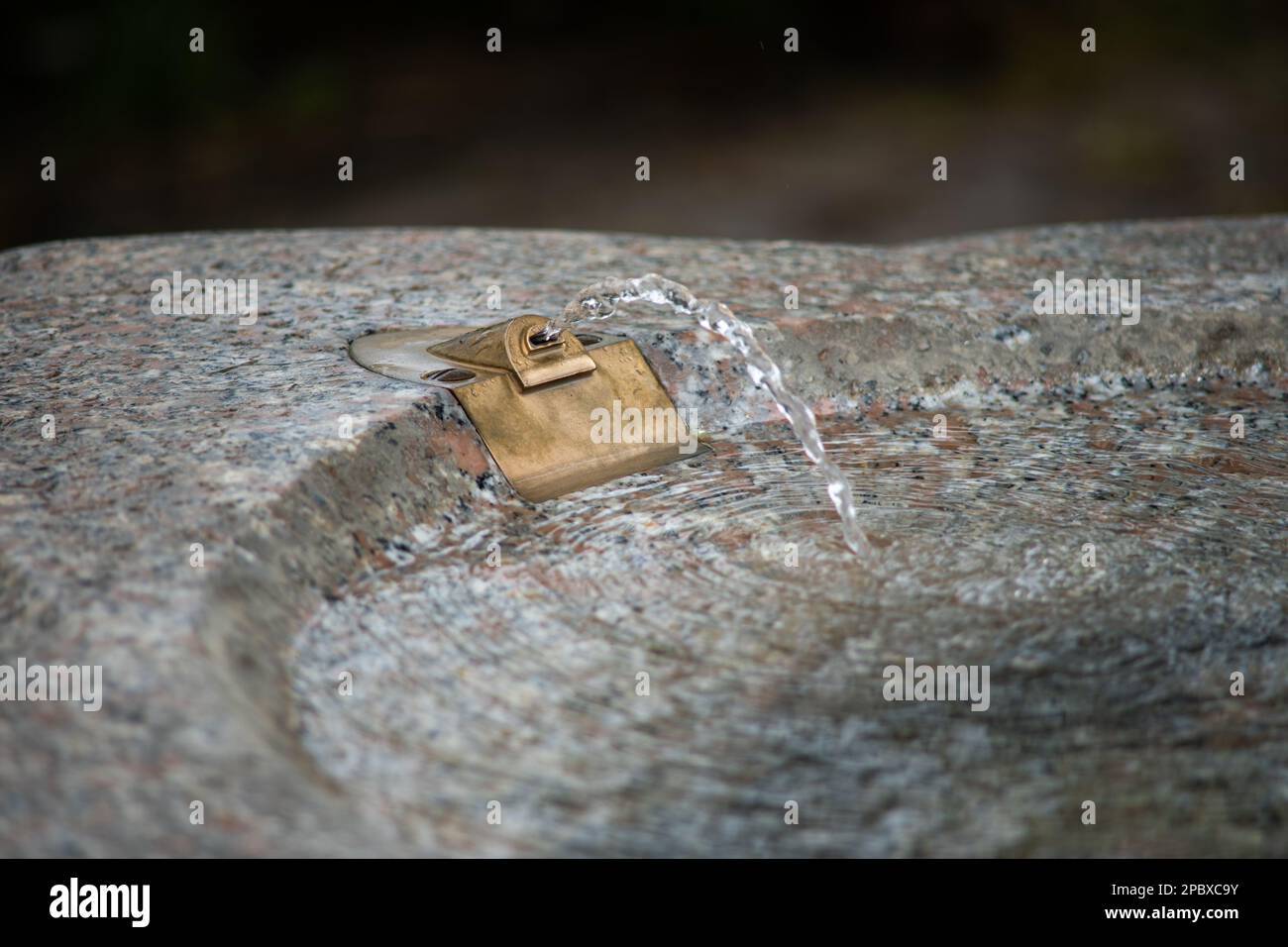 Public drinking water fountain, clear water flowing from metal faucet ...