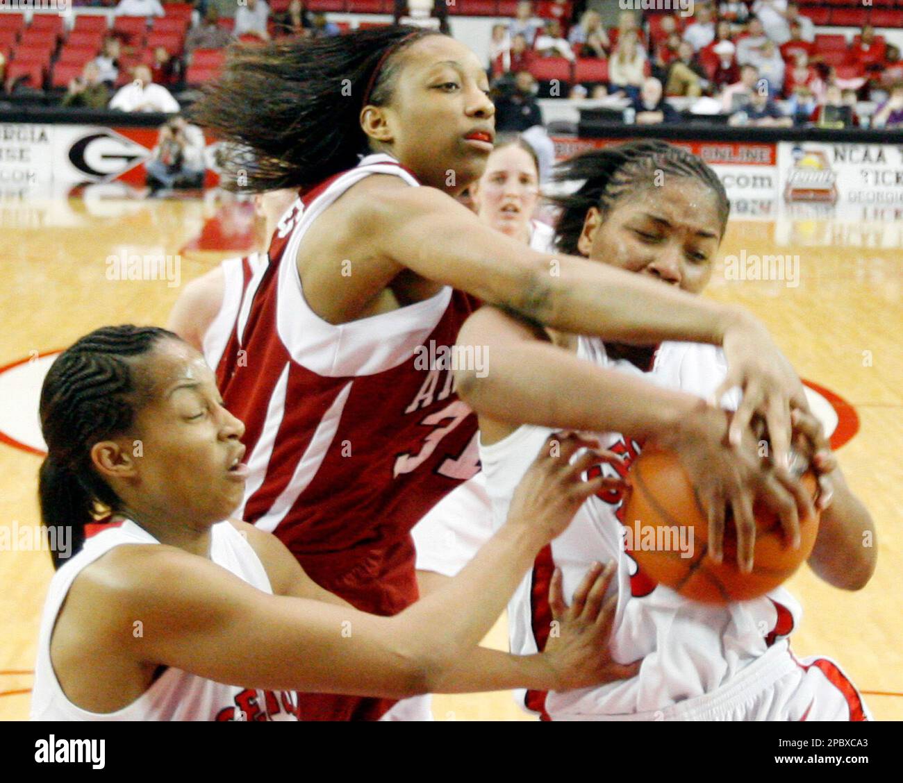 Arkansas' Whitney Jones, center, battles Georgia's Cori Chambers, left, and Tasha Humphrey ...