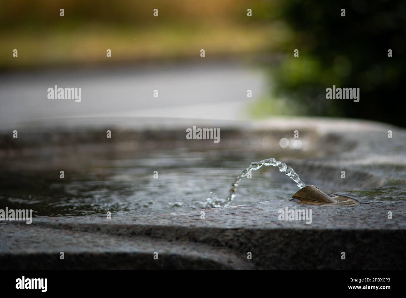 Public drinking water fountain, clear water flowing from metal faucet ...