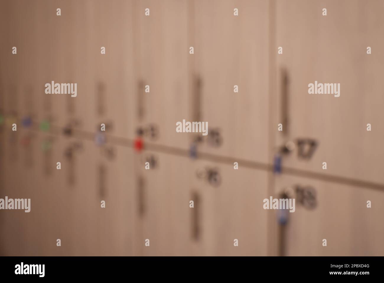 Blurred view of numbered wooden lockers with keys Stock Photo - Alamy
