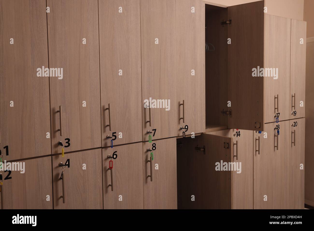 Many wooden lockers with keys and numbers on doors Stock Photo - Alamy