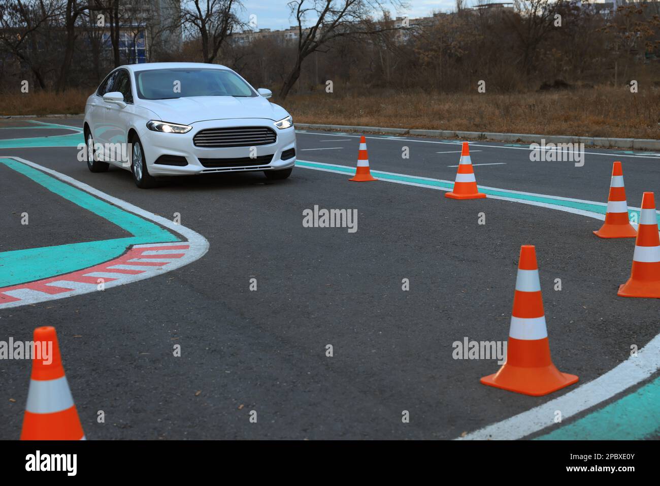 Modern car on driving school test track with traffic cones Stock Photo ...