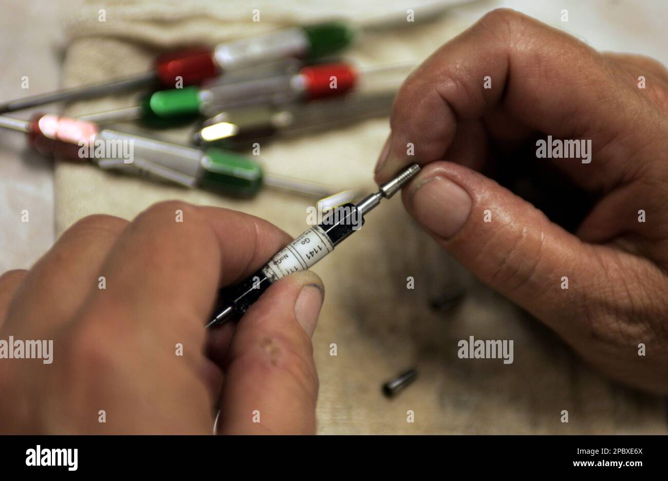 ** FILE ** An IMTEC worker displays some of the dental implants and ...