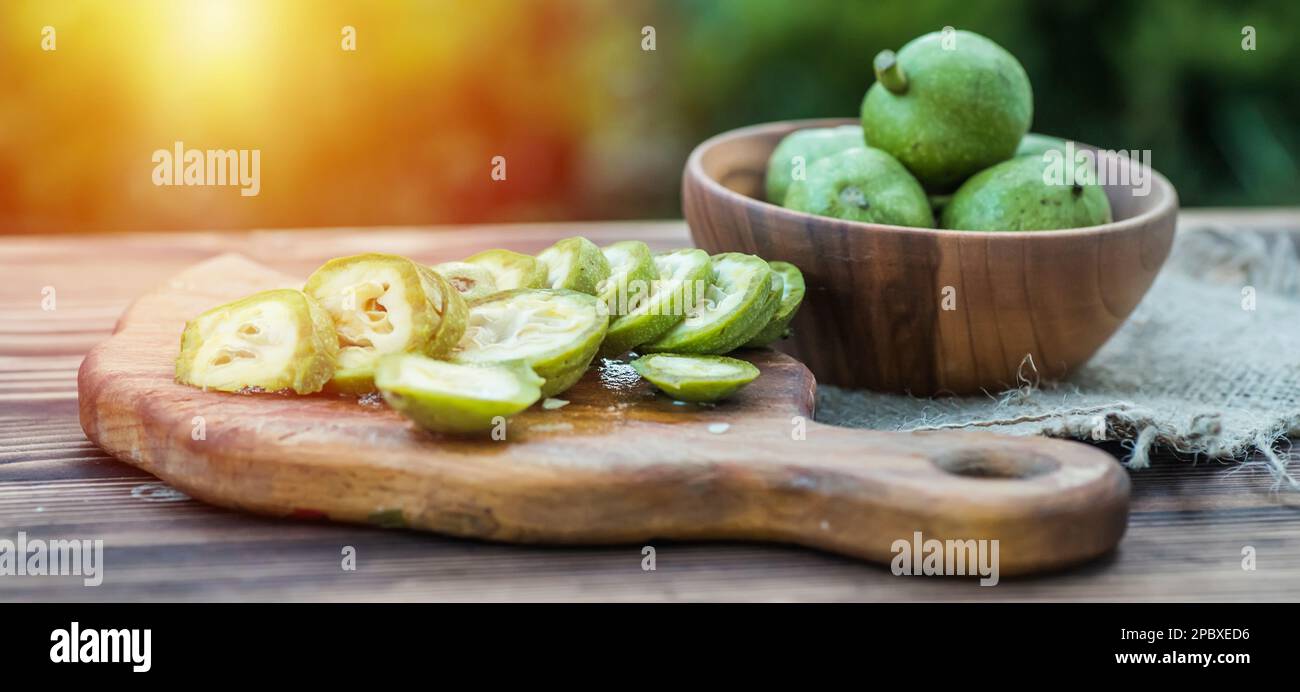 healthy food. Walnuts, cut into slices, are scattered on a cutting ...