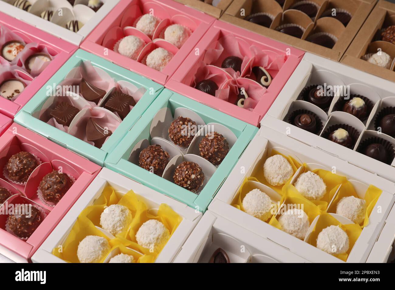 Many delicious candies in boxes. Production line Stock Photo - Alamy