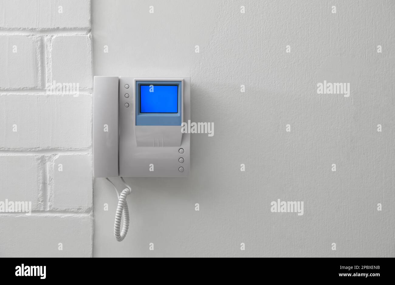 Modern intercom with camera installed on white wall Stock Photo - Alamy