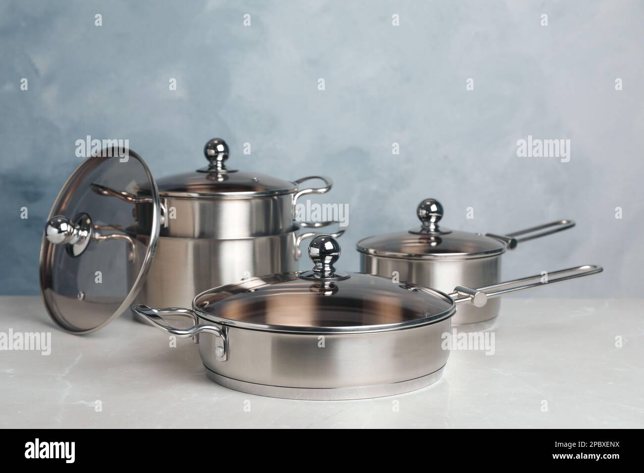 New cookware set on light grey table Stock Photo - Alamy