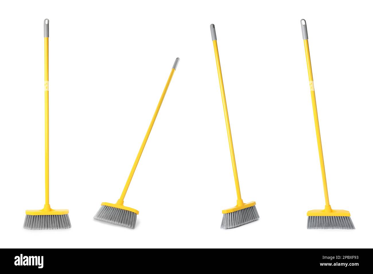 Set with plastic brooms on white background Stock Photo - Alamy