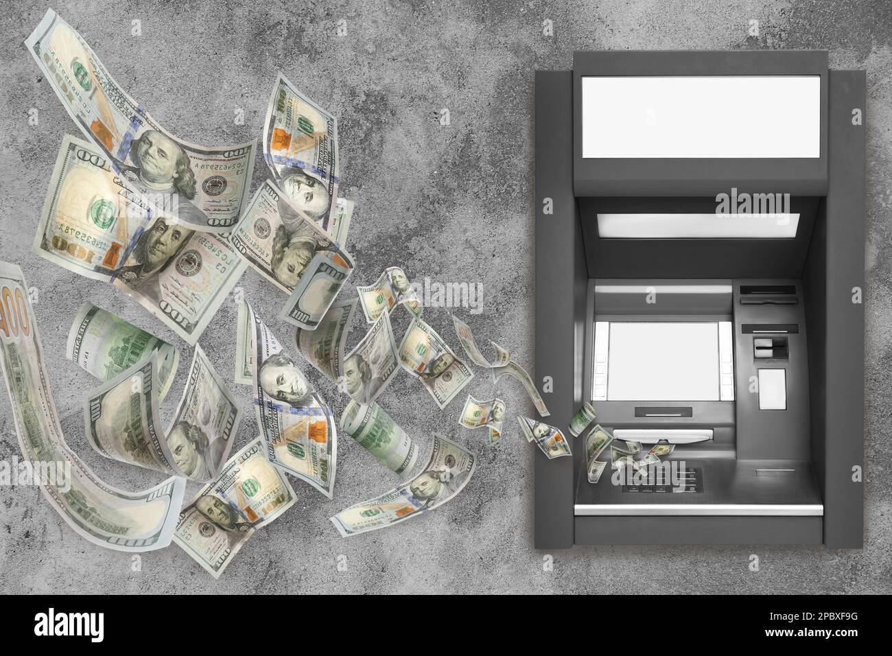 Modern automated cash machine and flying money on grey stone background ...