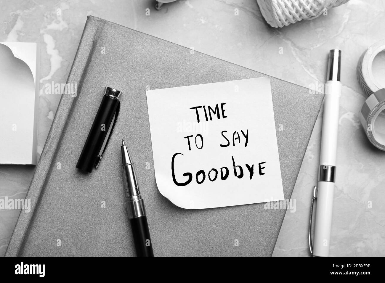 Note with text Tome to say Goodbye and stationery on table, flat lay ...