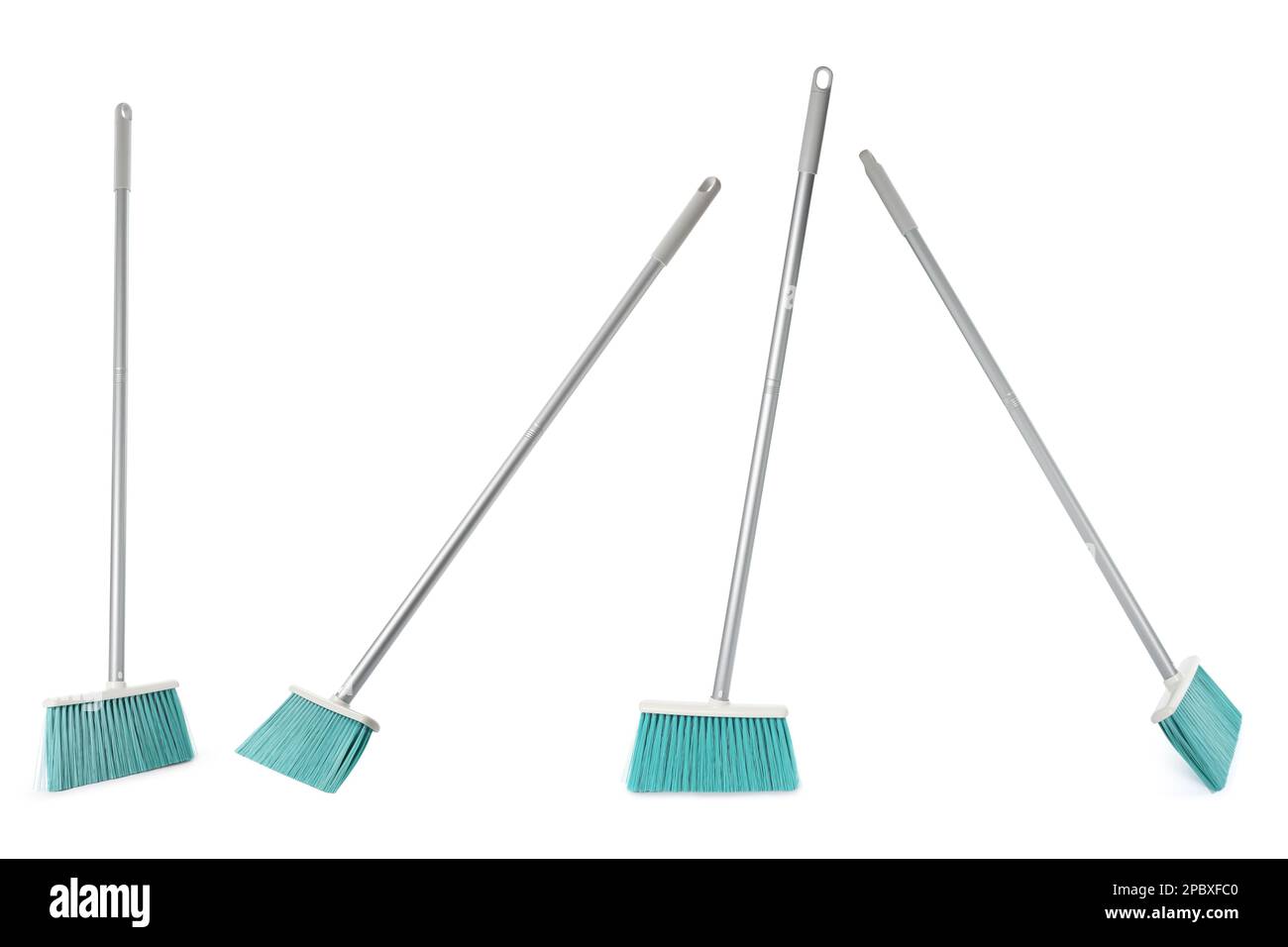 Set with plastic brooms on white background Stock Photo - Alamy