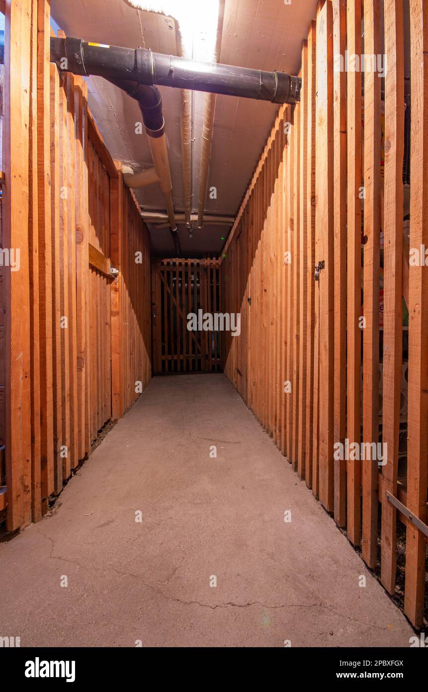 Residential apartment building basement or cellar corridor with wooden ...