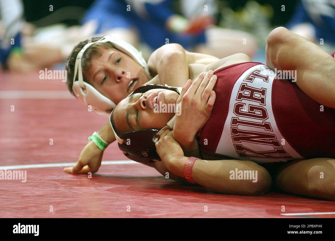 Don Bosco Gilbertville's Cole Welter, top, wraps up Mason City Newman's ...