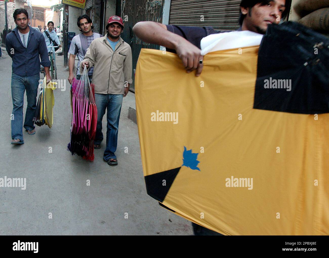 Pakistani youth hold different types of kites on their way to celebrate ...