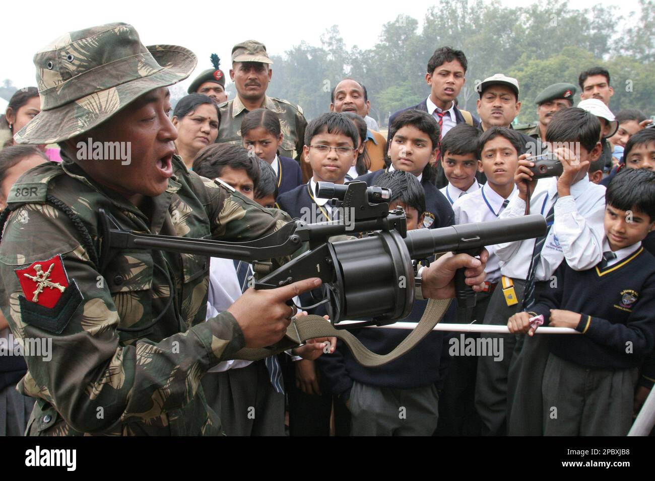 An Indian army soldier shows school children a 40 mm rocket launcher at ...
