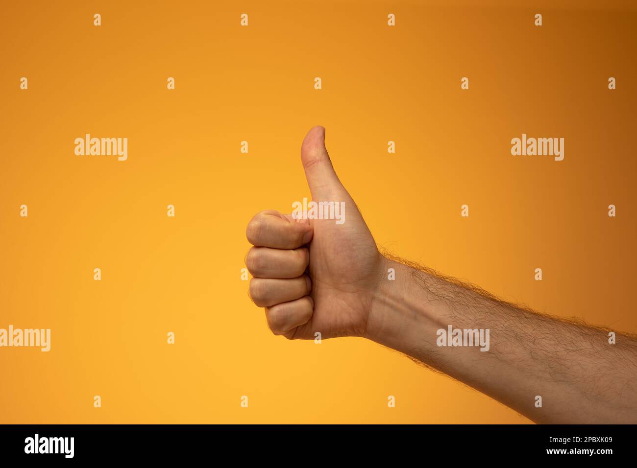 Thumbs up or OK sign made by Caucasian male hand. Close up studio shot ...