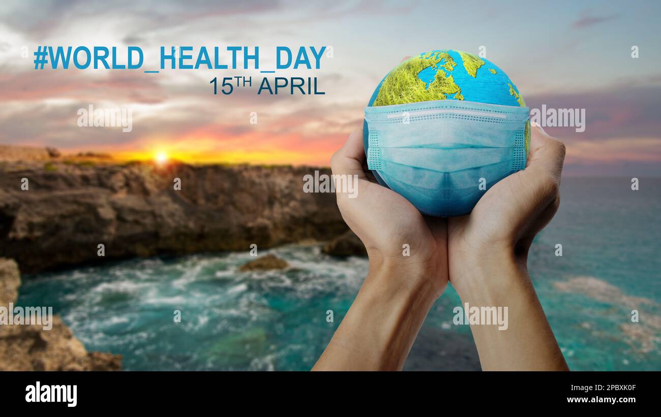 Human hand showing earth with a face mask. World Health Day Concept ...
