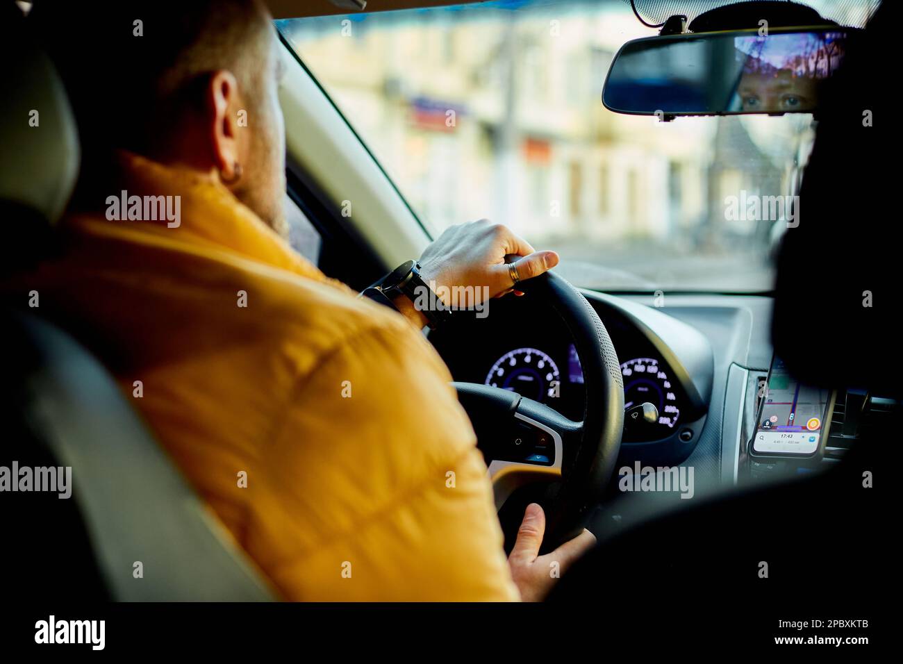 Male driving car, Concentrated bearded man in casual clothes driving ...