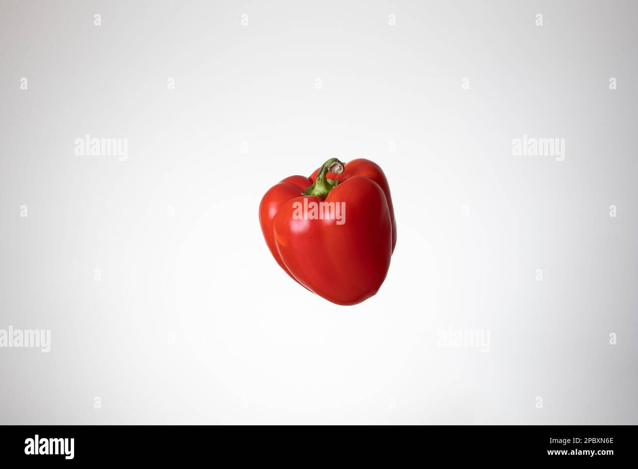 Fresh whole red bell pepper. Close up studio shot, isolated on a white ...