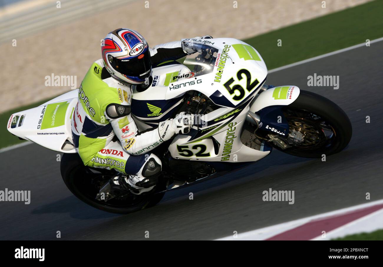 British rider James Toseland steers his Honda motorcycle during a ...
