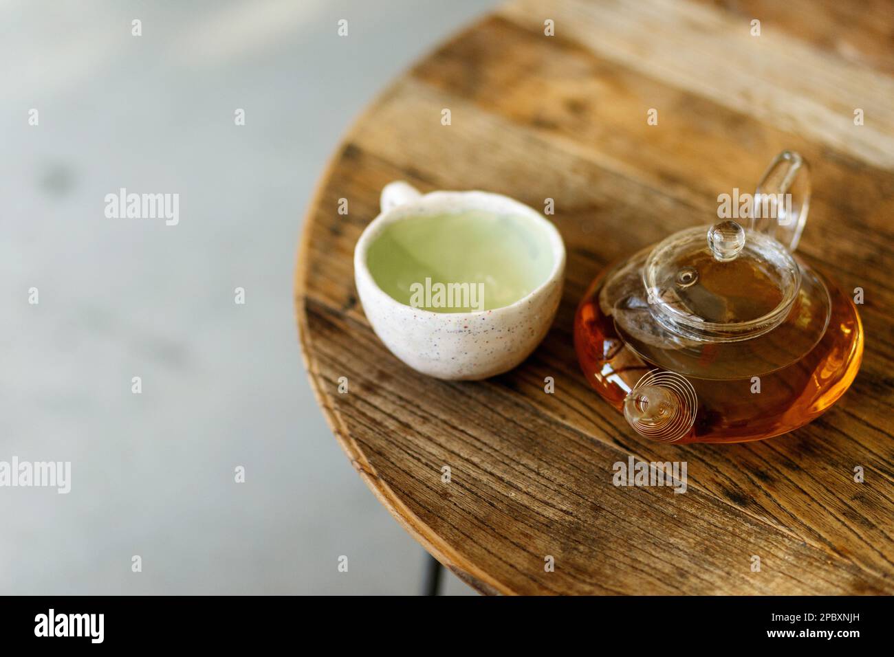 Warm cup of tea with teapot on the wooden desk at morning with banner ...