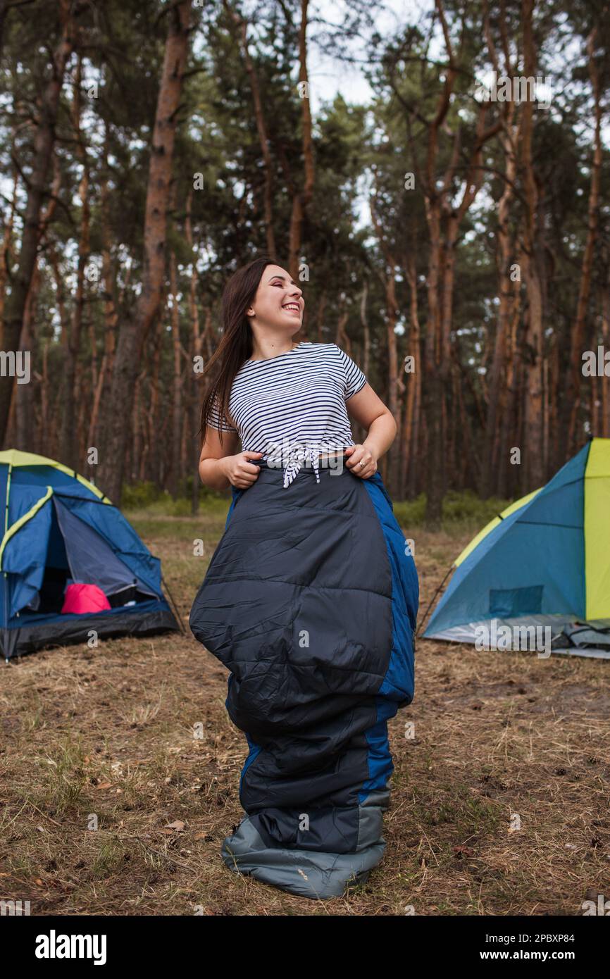 Happy woman comfortortable tourist sleeping bag concept Stock Photo - Alamy