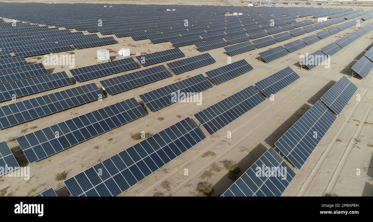 HAMI, CHINA - MARCH 12, 2023 - Dark blue solar panels stretch across ...